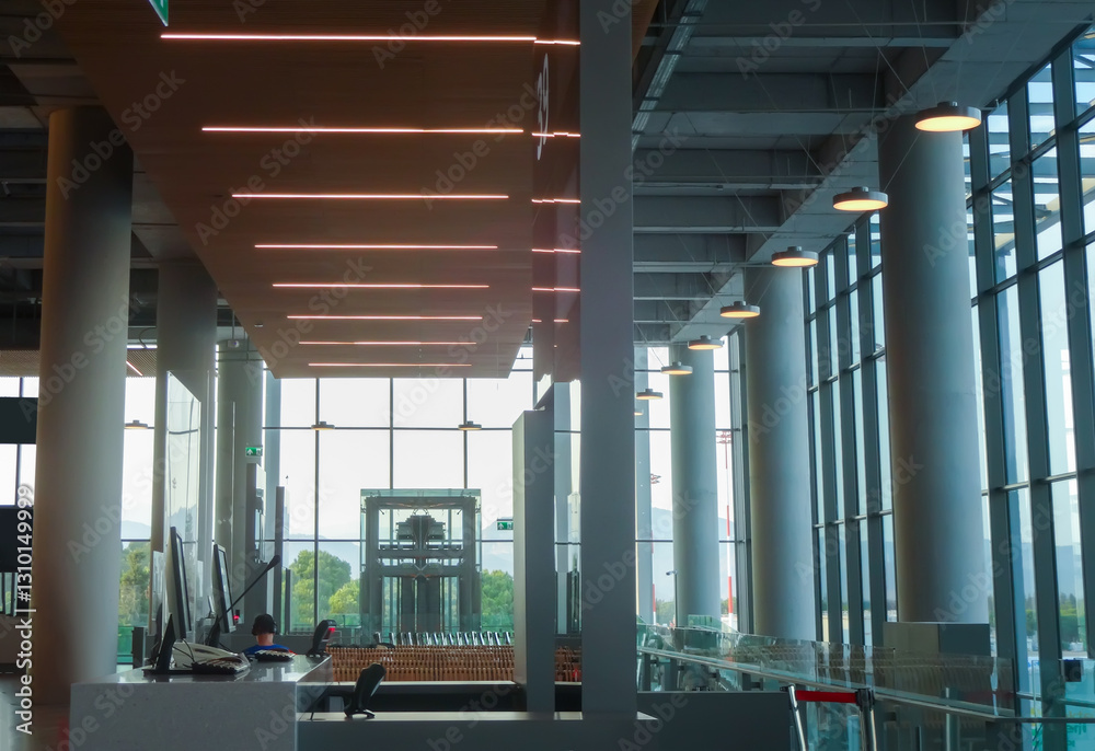 Interior of a modern international airport. High windows and columns ...