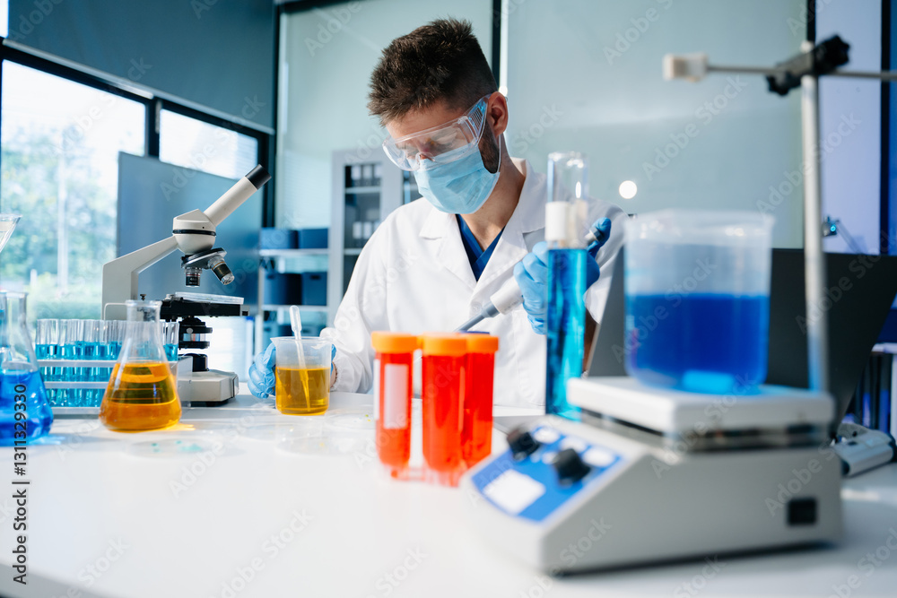 Scientist mixing chemical liquids in the chemistry lab. Researcher ...