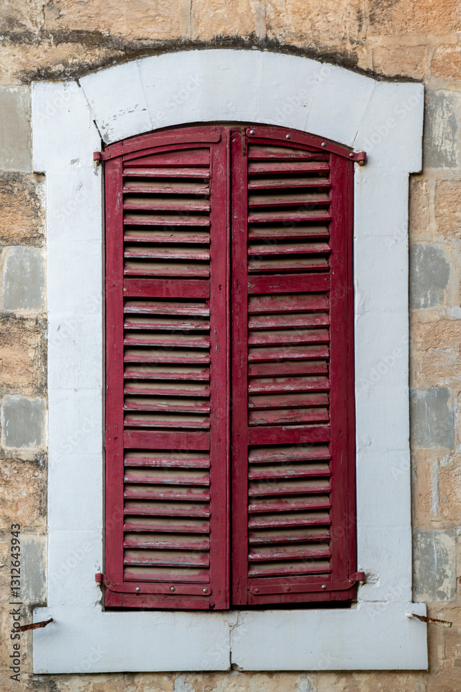Red shuttered windows of a Templar style house with built by Germans in ...