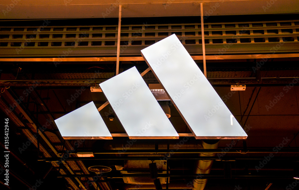 Iconic Adidas logo displayed on store sign. The three white stripes ...