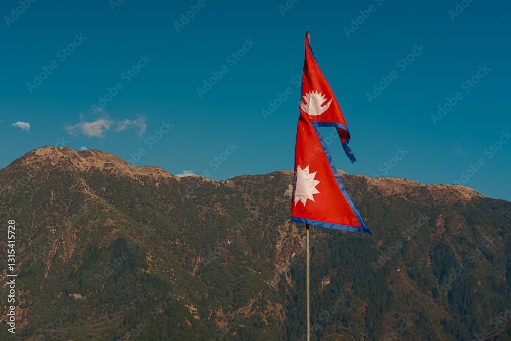GHOREPANI, NEPAL - JANUARY 9, 2025: Nepal flag against green hills and ...