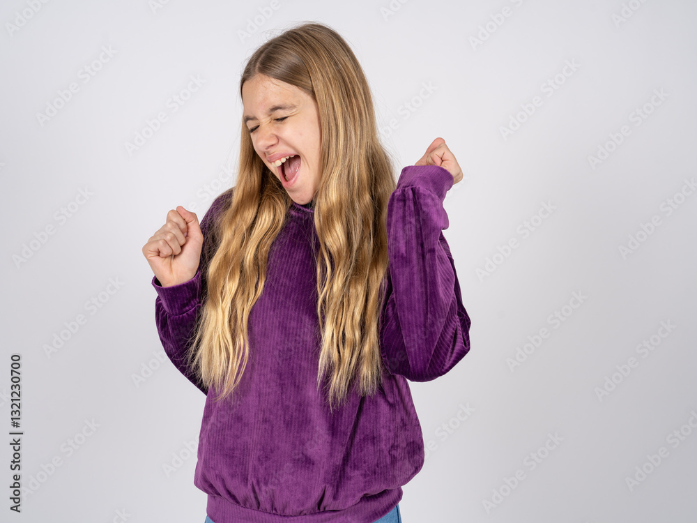 Ecstatic beautiful teen girl wearing purple sweater shout loud yeah ...