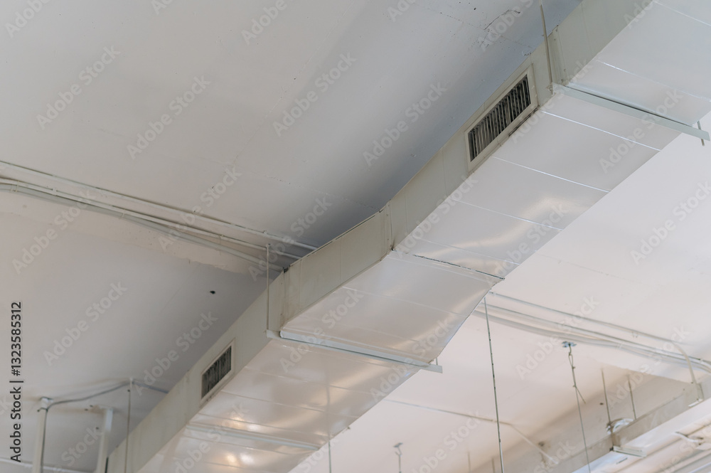image shows modern air conditioning duct system installed in ceiling of ...