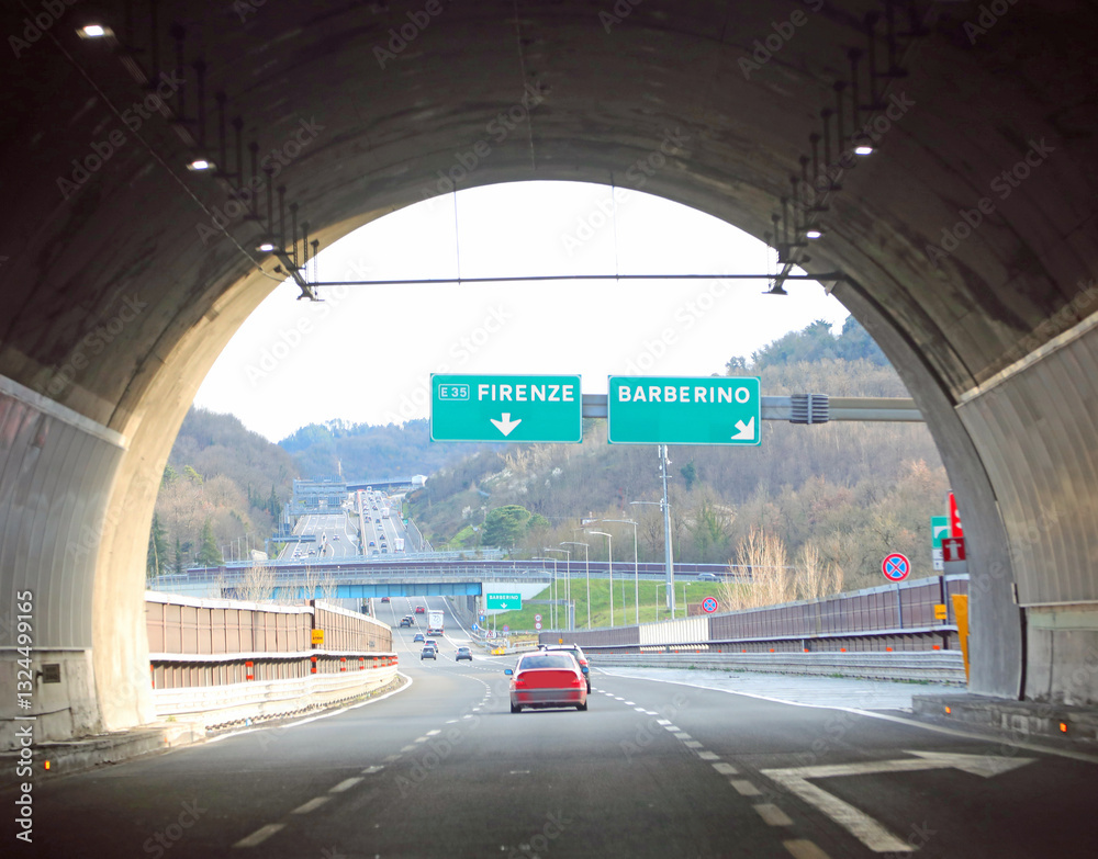 Exit of the Italian motorway tunnel with road signs for Florence or the ...