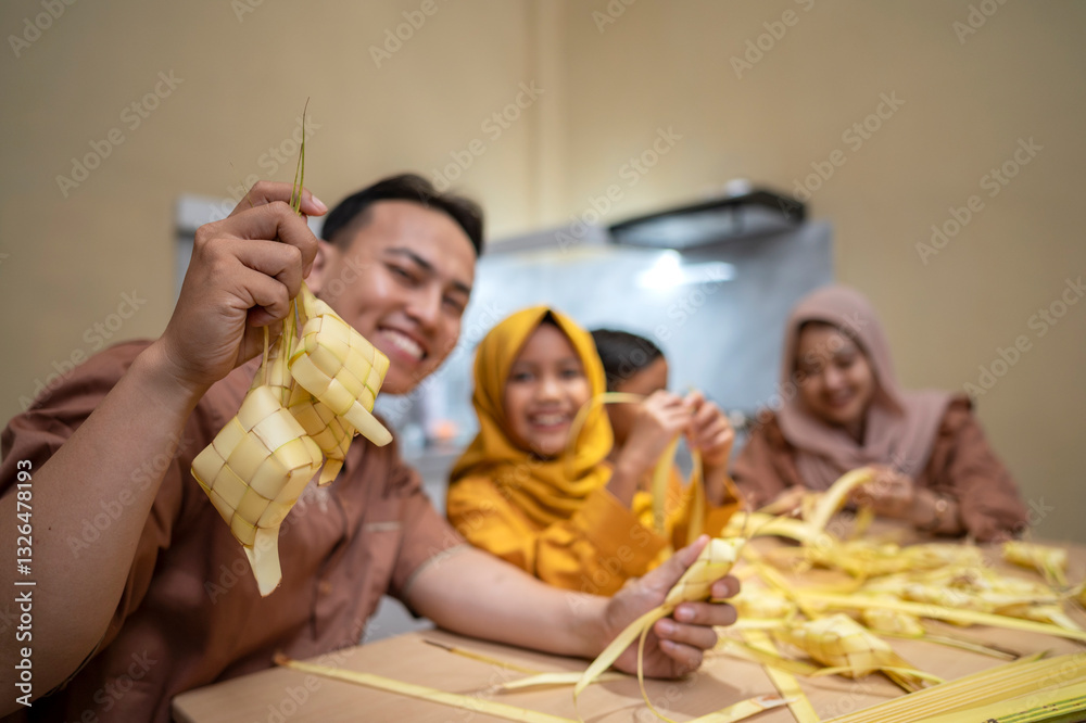 Indonesian Muslim family weaving ketupat rice dumpling from young ...