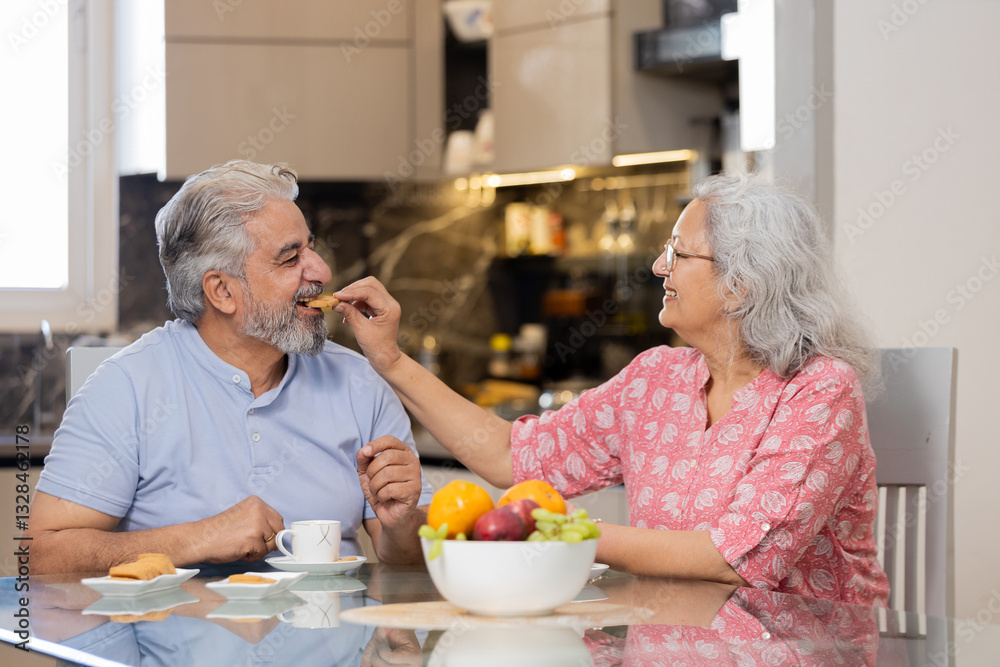 Happy retired senior indian couple eating healthy breakfast together ...