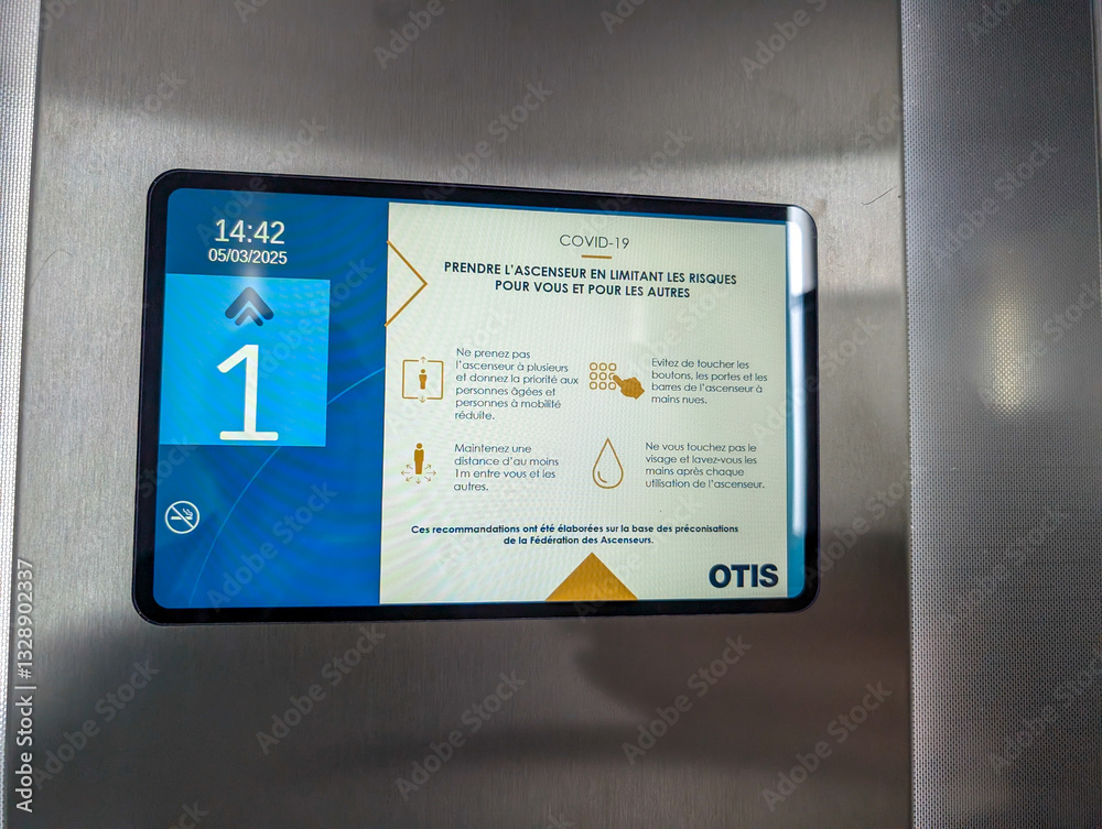 France, 05 March 2025 : Elevator screen displaying health safety ...