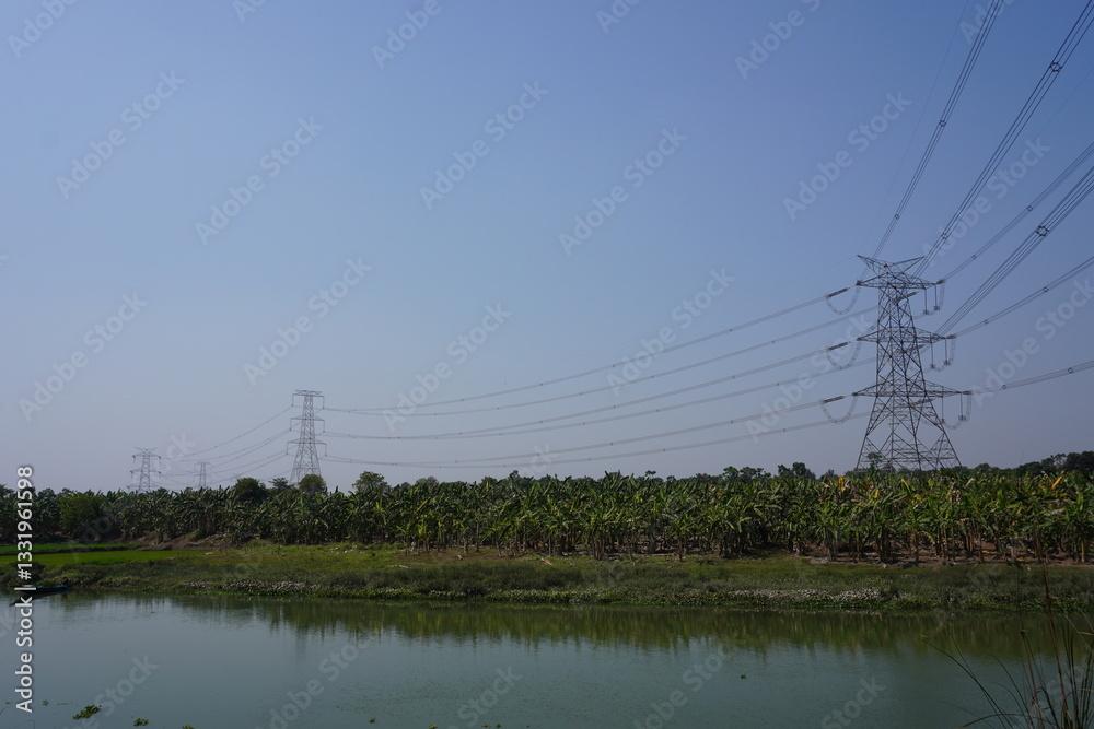 Overhead power lines supported by transmission towers which are used to ...