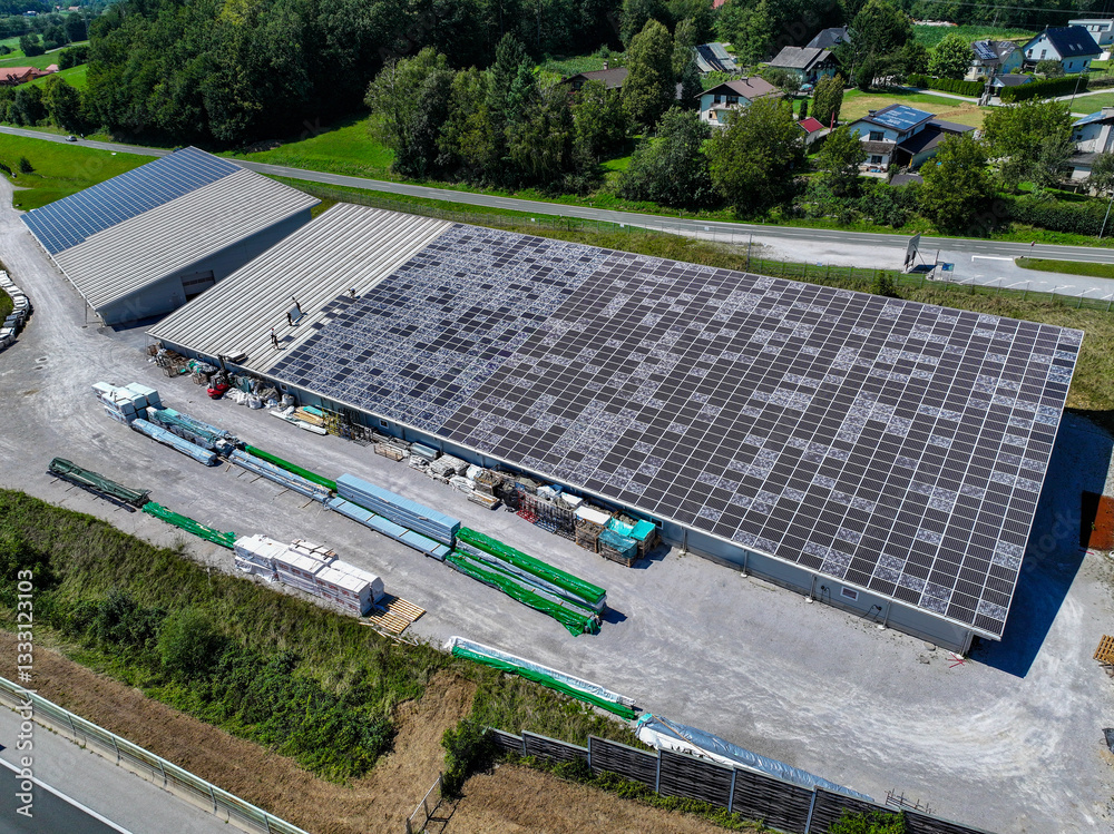 AERIAL: Large industrial building with damaged solar panels covering ...
