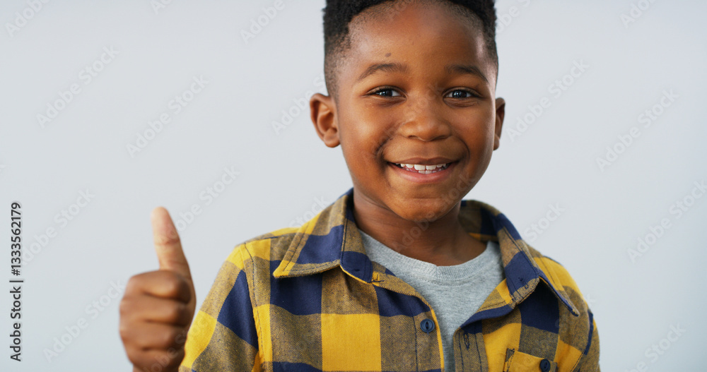 Portrait, smile and boy with thumbs up in studio of good news, positive ...
