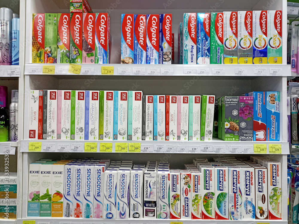 Variety of toothpaste brands on store shelves with colgate oral-b blend ...