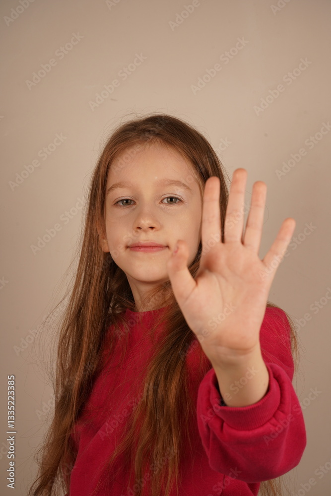 It s a sign of setting boundaries. With a raised hand, the young girl ...