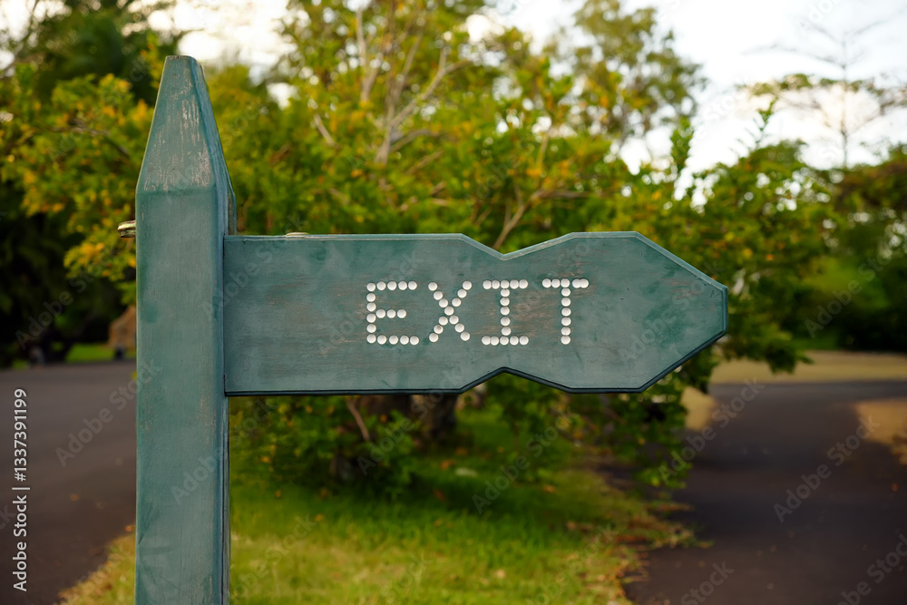 Green wooden exit sign in garden path. Park exit sign with LED dots ...