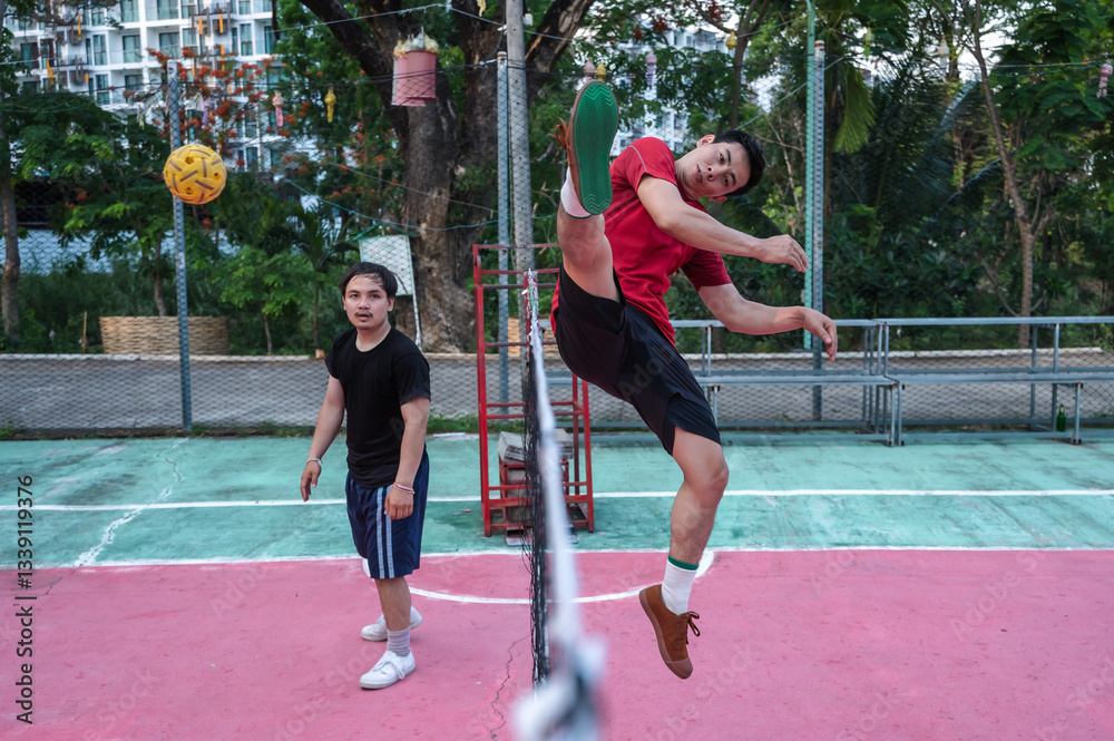 Asian male Sepaktakraw players playing traditional Sepak Takraw sports ...