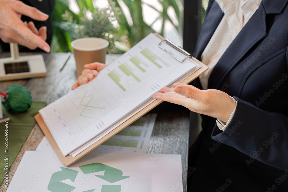 Data Analysis and Environmental Impact. A businesswoman reviewing ...