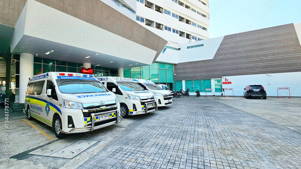 Hospital Ambulance Fleet: A row of ambulances parked outside a modern ...