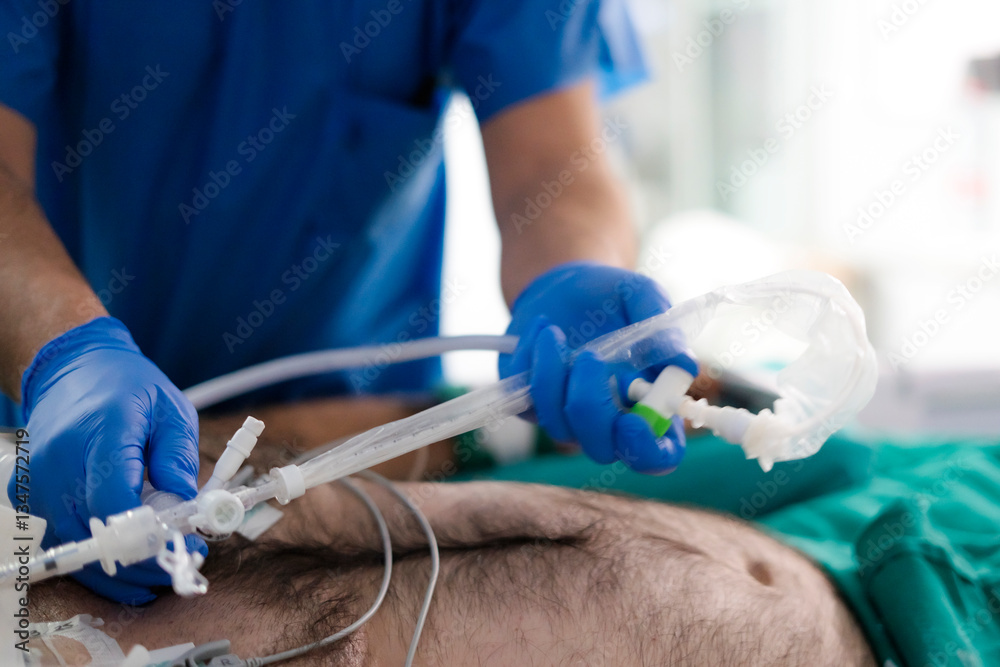 Surgeon preparing drainage system for patient after surgery in ...