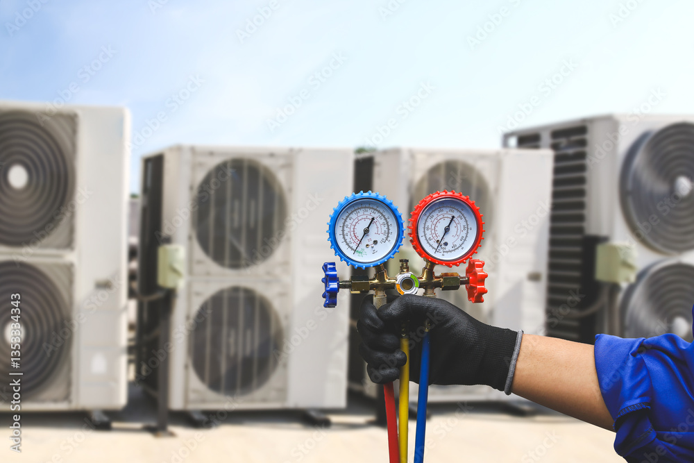 Electrical conditioning service technician using measuring manifold gauge checking HVAC ...