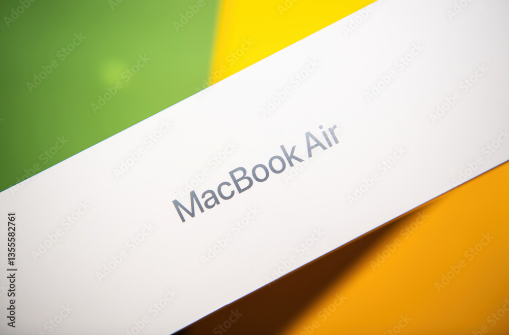Paris, France - Mar 13, 2025: Clean white MacBook Air M4 box is placed on a vibrant green and ...