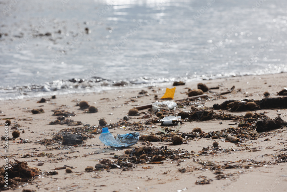 Plastic bottles, bags, and debris scattered across the shoreline ...