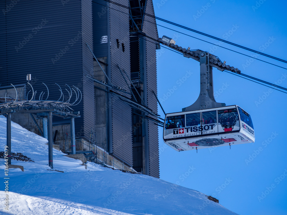 Mountain cable car arriving at the upper station of Glacier 3000 ...