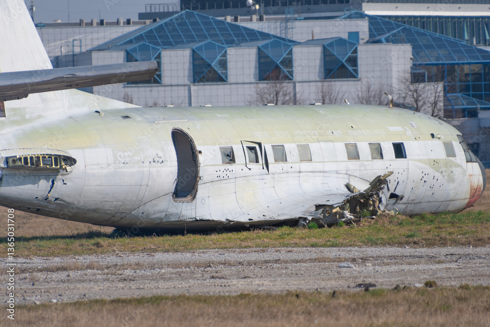 Abandoned aircraft fuselage with missing parts, broken windows, and a ...