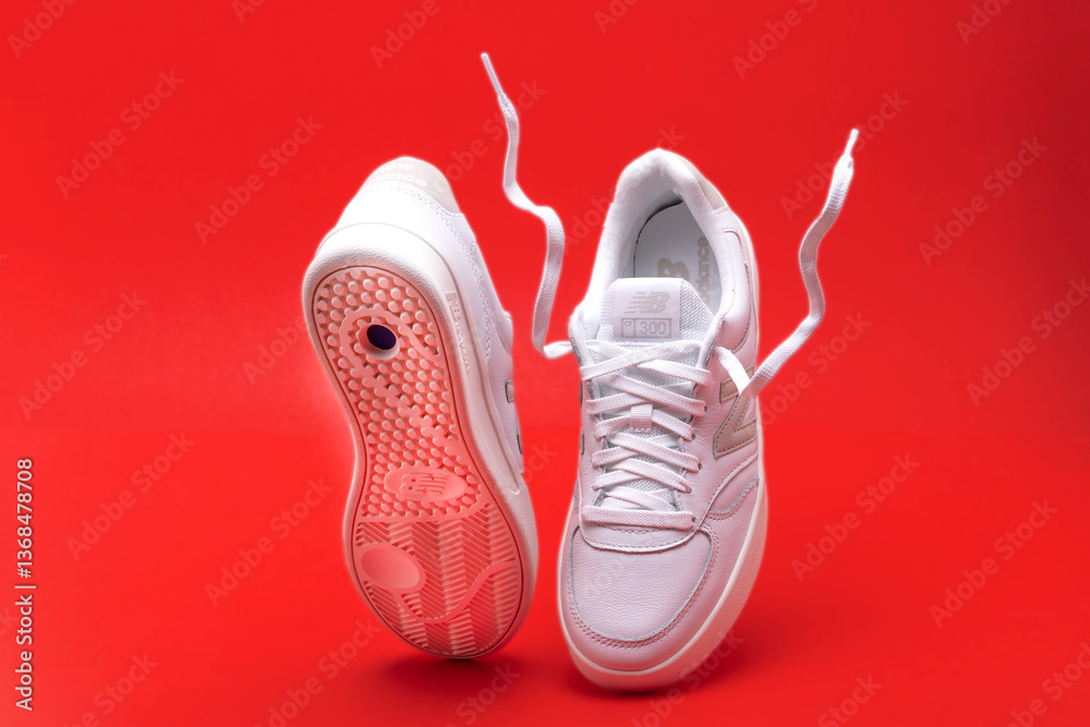 Stylish pair of white leather New Balance 300 sneakers with laces on a ...
