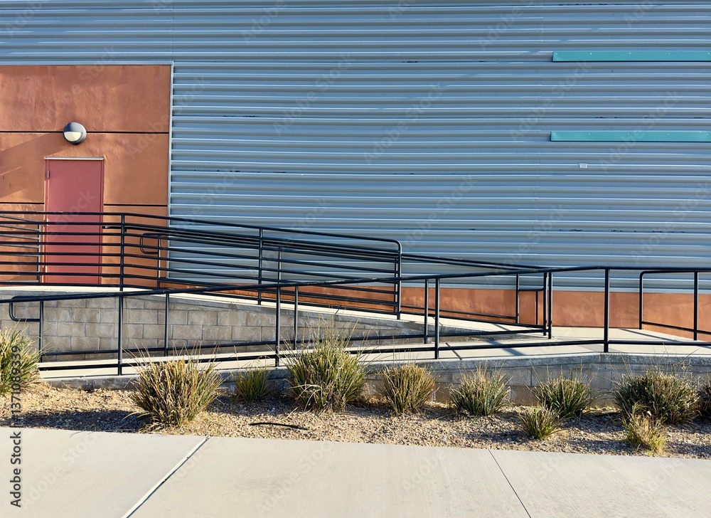 rear exit door of a commercial building with concrete ramp metal ...