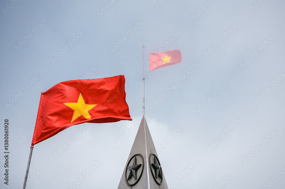 Vietnamese national flags waving in the wind next to the iconic ...