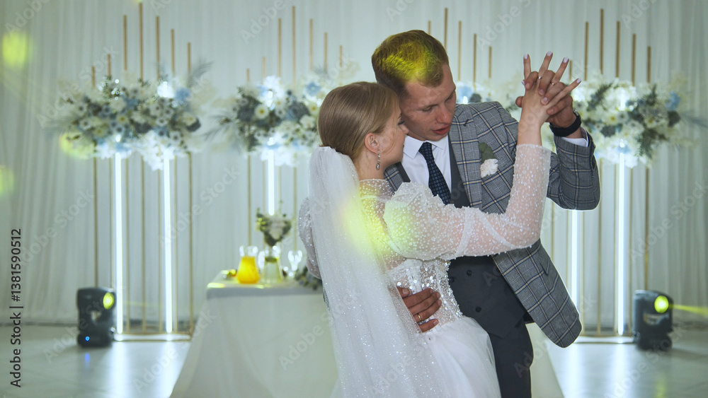 Newlywed couple enjoying their first dance together as husband and wife ...
