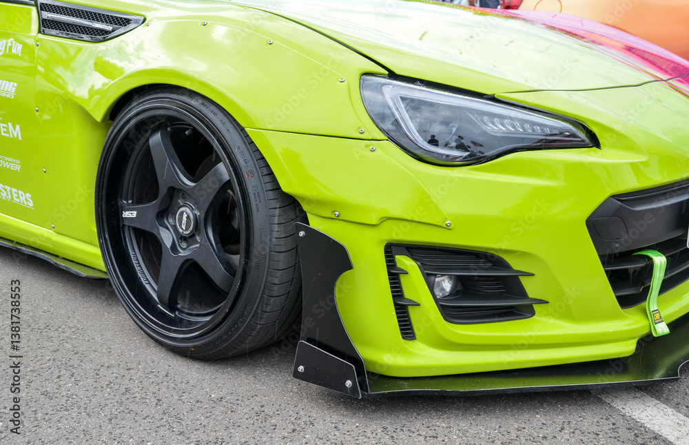 Lime green Subaru BRZ sports car with black wheels, wide fenders, and a ...