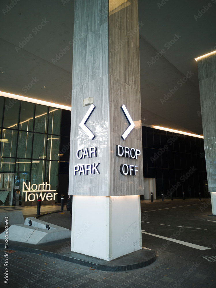 Illuminated signs of car parking and drop-off point on the building ...