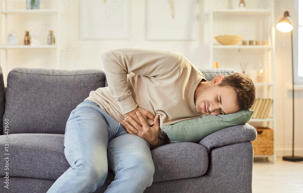 Sick man on sofa, touching belly in bad suffer from stomach ache, ill ...