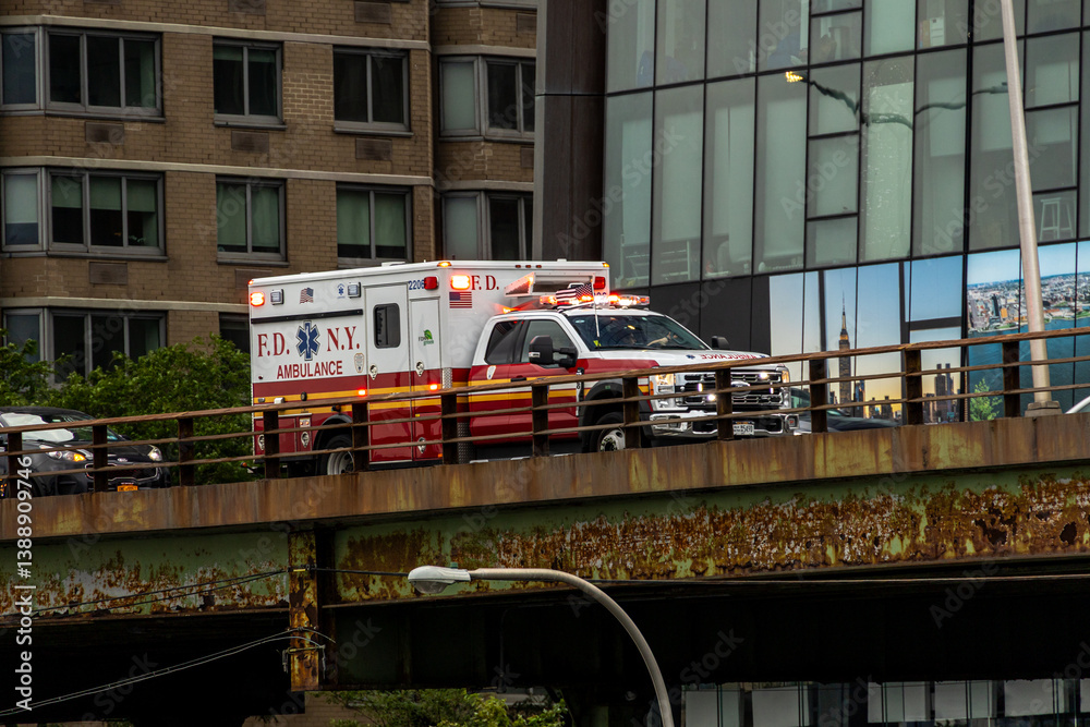 FDNY ambulance. Ambulance with flashing lights on an elevated urban ...