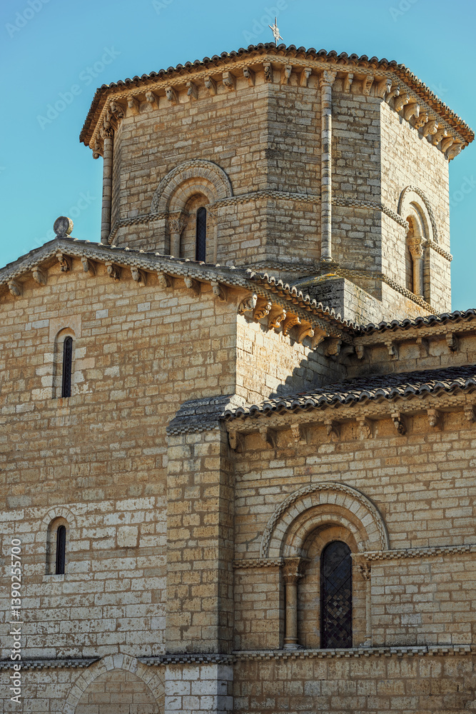 Apse and tower of a Romanesque stone church with corbels and arched ...
