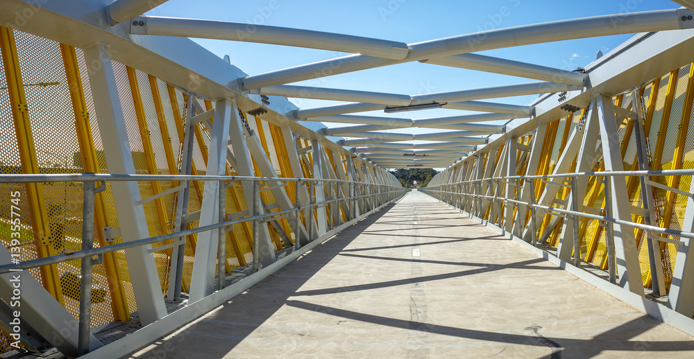 A modern pedestrian bridge with crossbeam structure forms part of ...