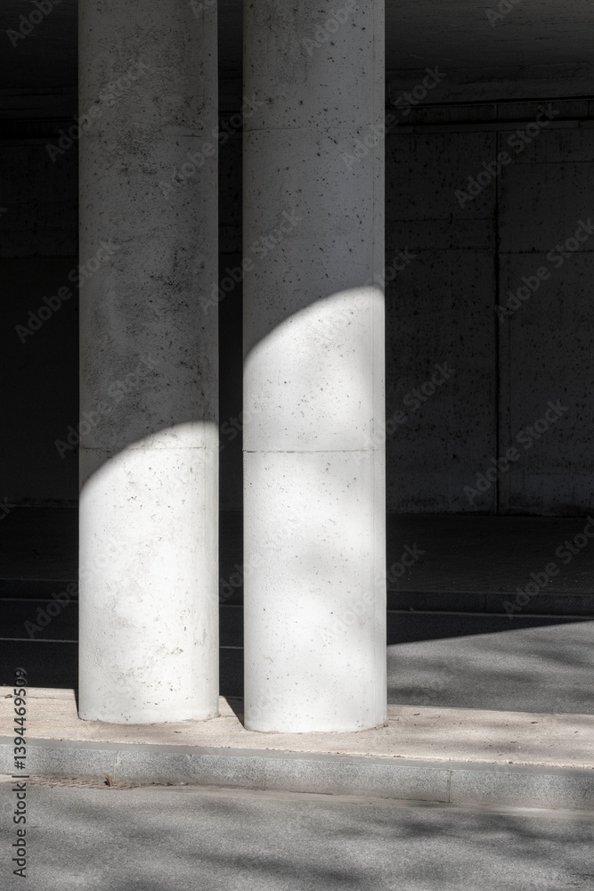 Concrete architectural pillars with minimal light and shadow play ...