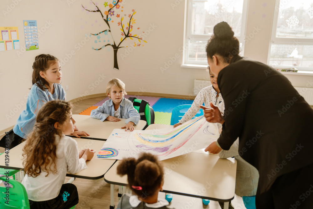 A diverse group of five school-aged kids sitting in their first-grade ...