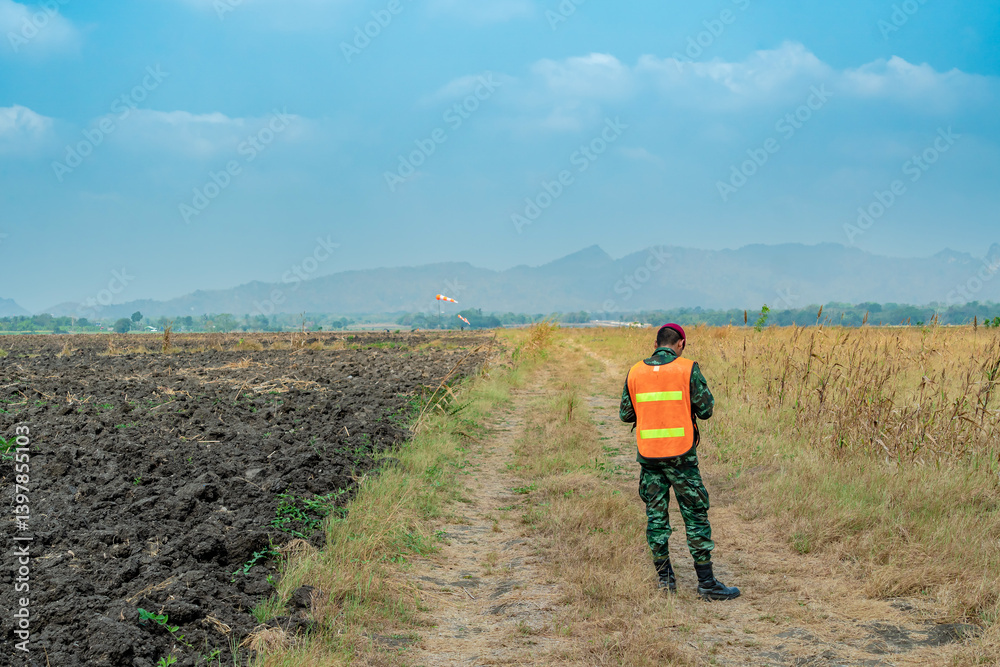 Reconnaissance infantry using cell phones in fields to send news to ...