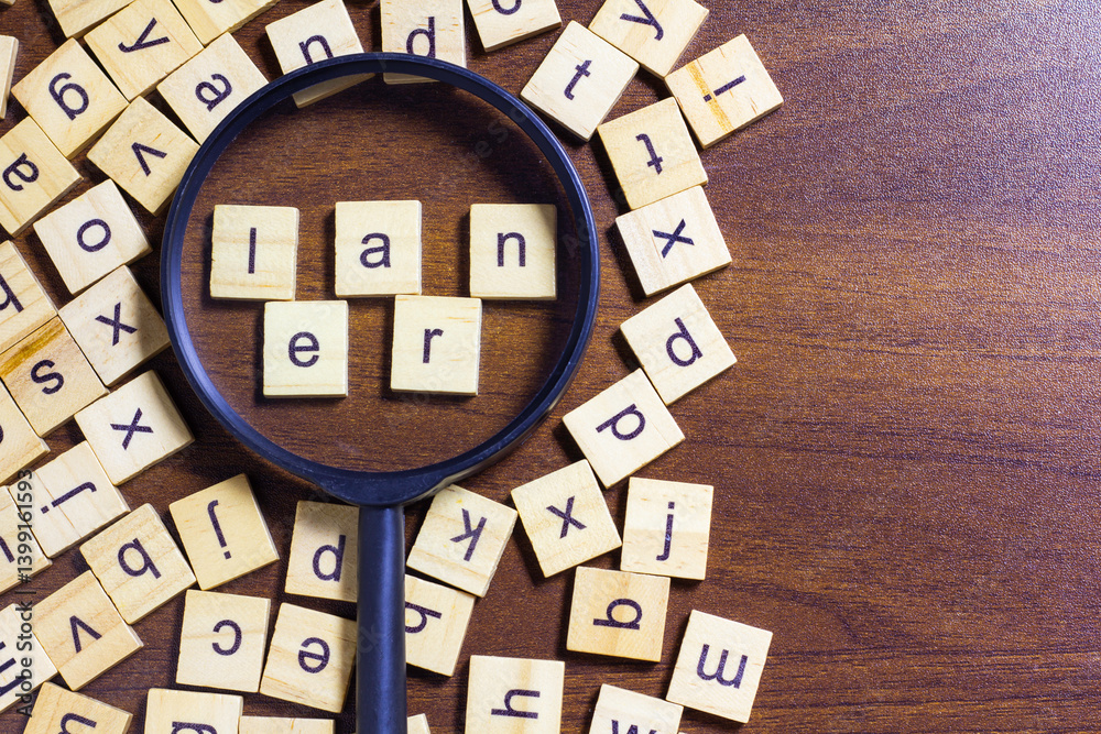 English letters scattered on wooden table surface. Idea to develop ...