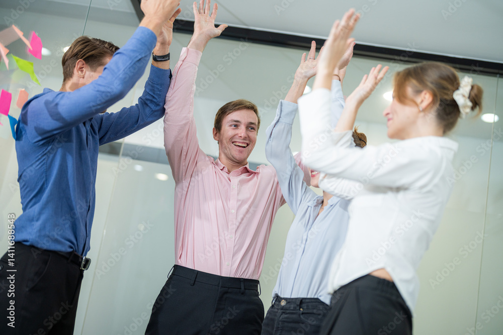 Team celebrates success during a brainstorming session in a modern ...