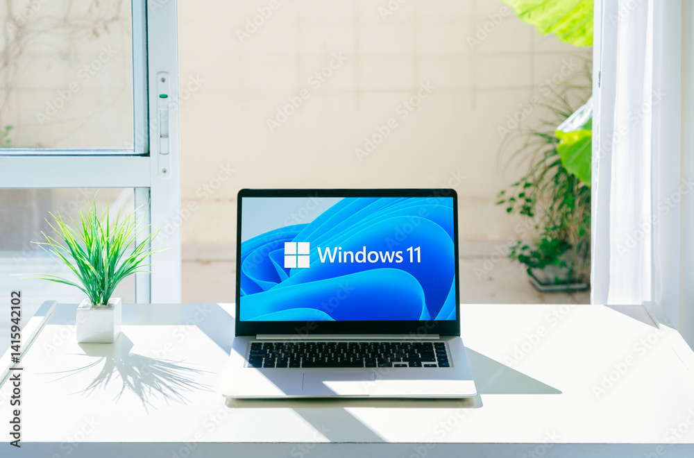 Windows 11 logo on the laptop screen. The most popular operating system ...