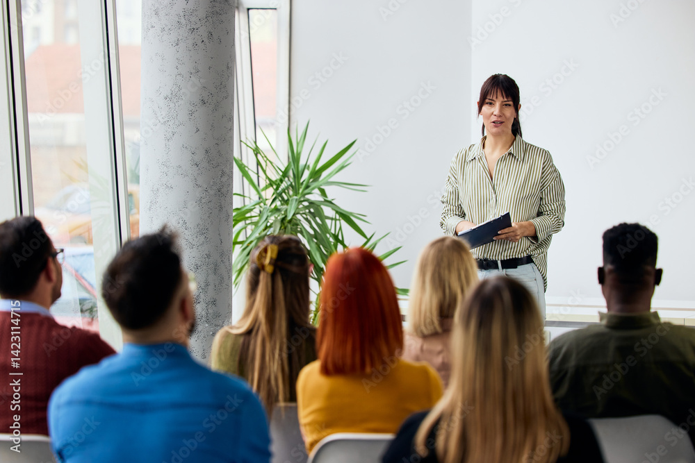 Presenter Speaking to Audience in Conference Room During a Business ...