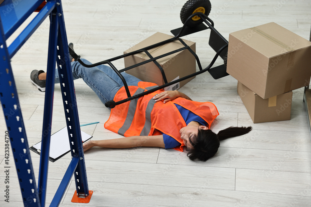 Accident at work. Unconscious woman and overturned hand truck on floor ...