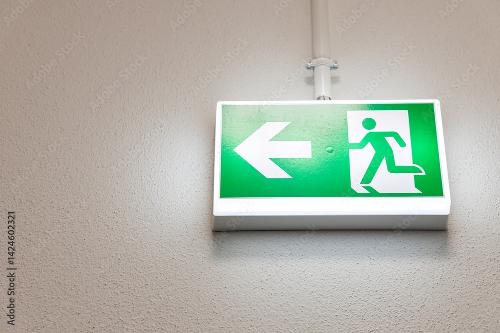Fire Emergency exit sign on the wall background inside building. Safety ...