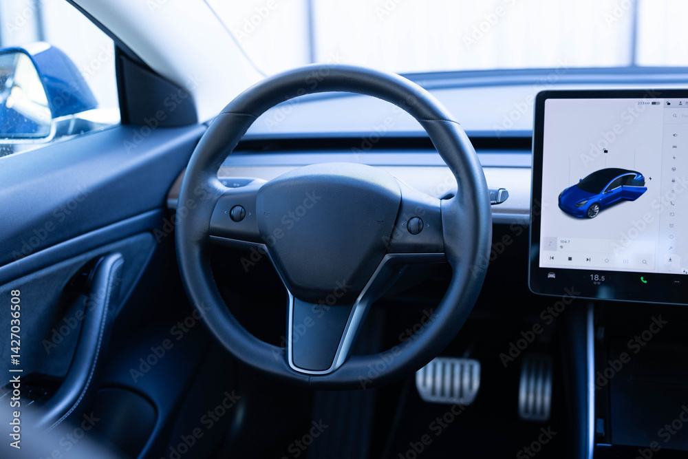 Close up of steering wheel of a new electric vehicle, interior cockpit ...