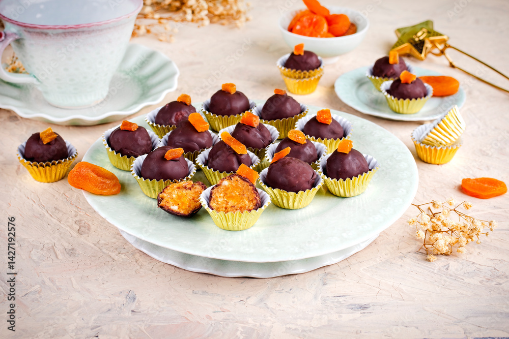 Artisan homemade pralines with dried apricots, fruits and nuts, coated ...