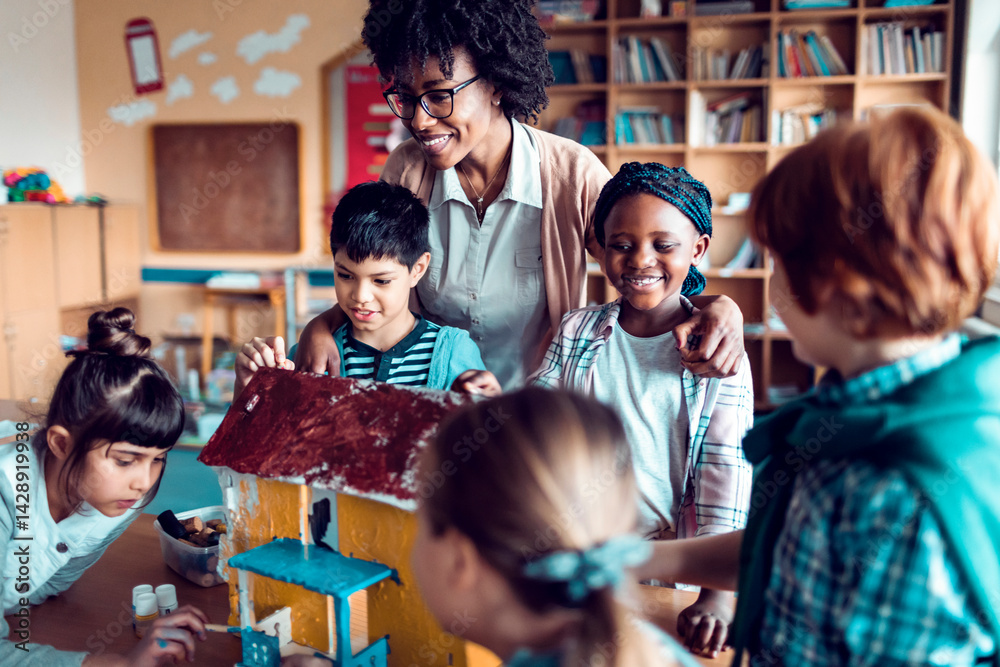 Elementary school teacher guiding diverse group of kids with arts and ...