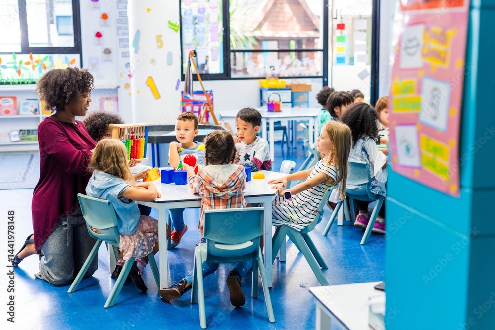 Diverse classroom with children and a teacher. Kids of various ethnicities learning together ...