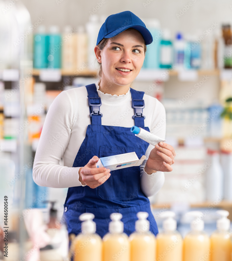 Builder woman in blue overall buyer select joint pain ointment, reads ...